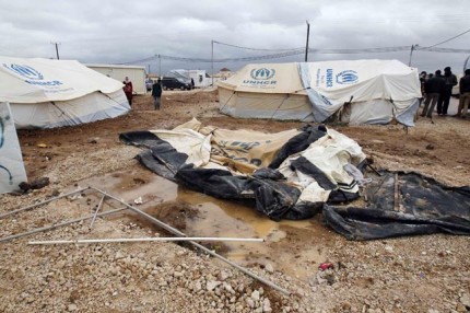 A damaged tent is seen after heavy rain at the Al-Zaatari refugee camp ...